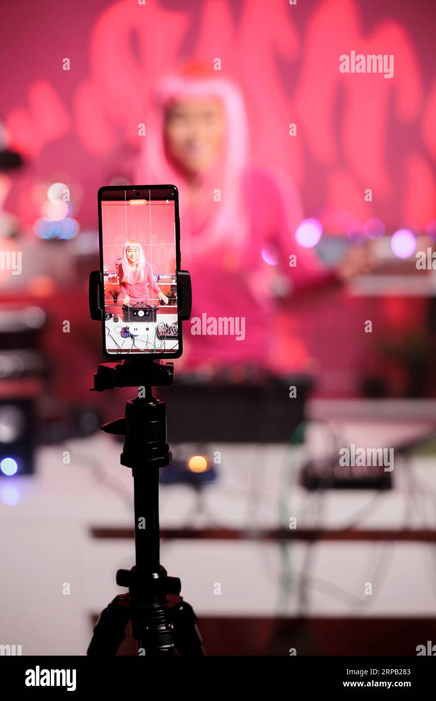 Asian female having fun while recording video with her performing ...