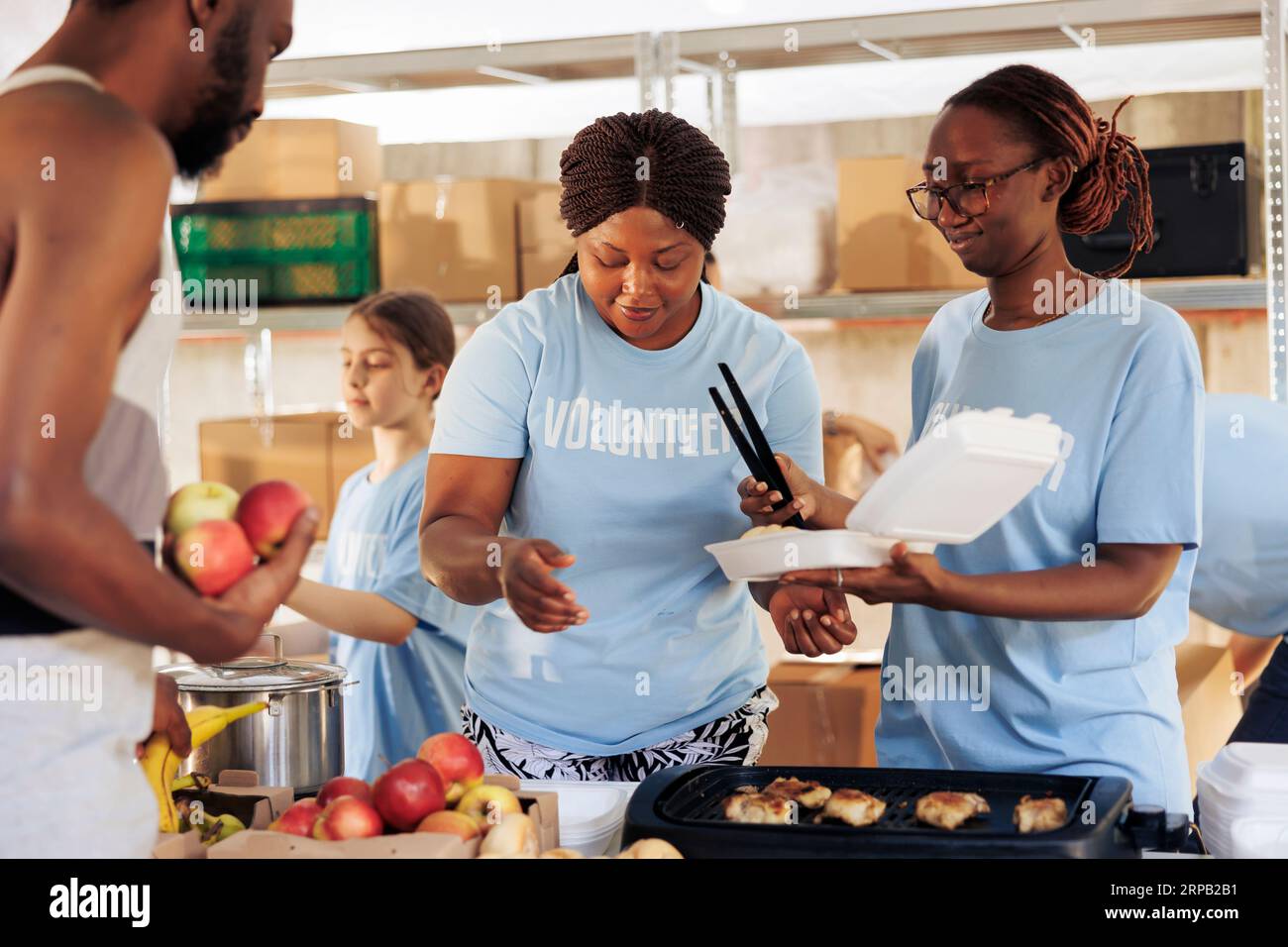 Friendly black women happily serving free food to the poor and needy ...