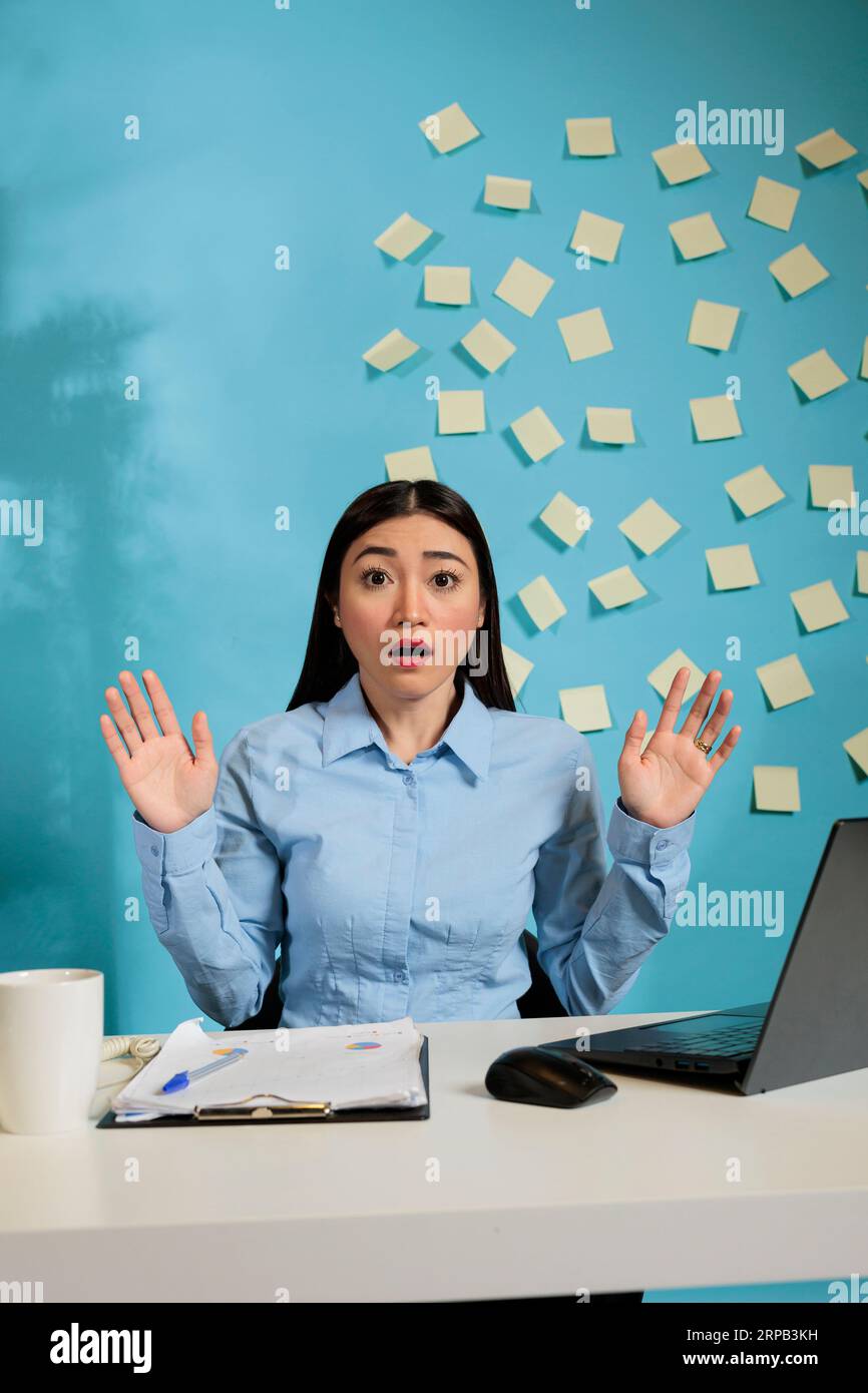 Woman showing a surprised expression, gesturing with hands in disbelief ...
