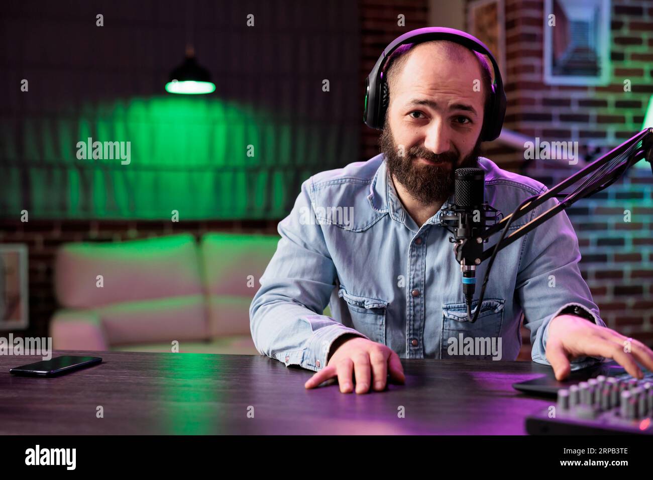 Portrait of expert radio host playing music in professional on air home ...