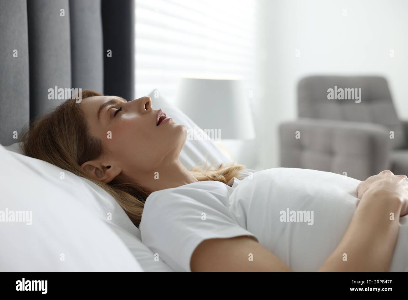 Woman snoring while sleeping in bed at home Stock Photo - Alamy