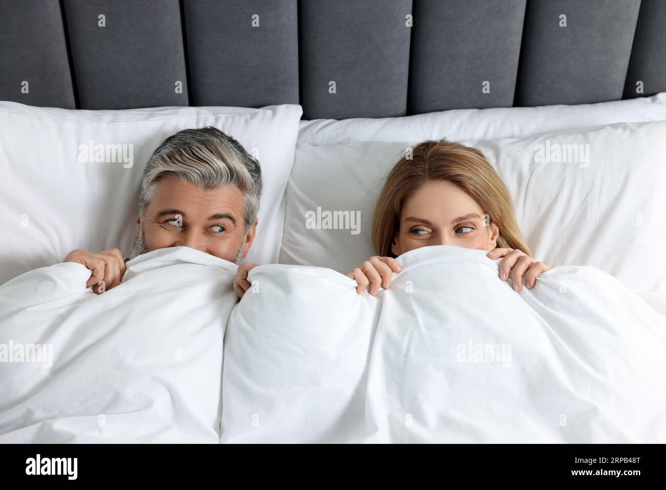 Happy family hiding under blanket hi-res stock photography and images ...