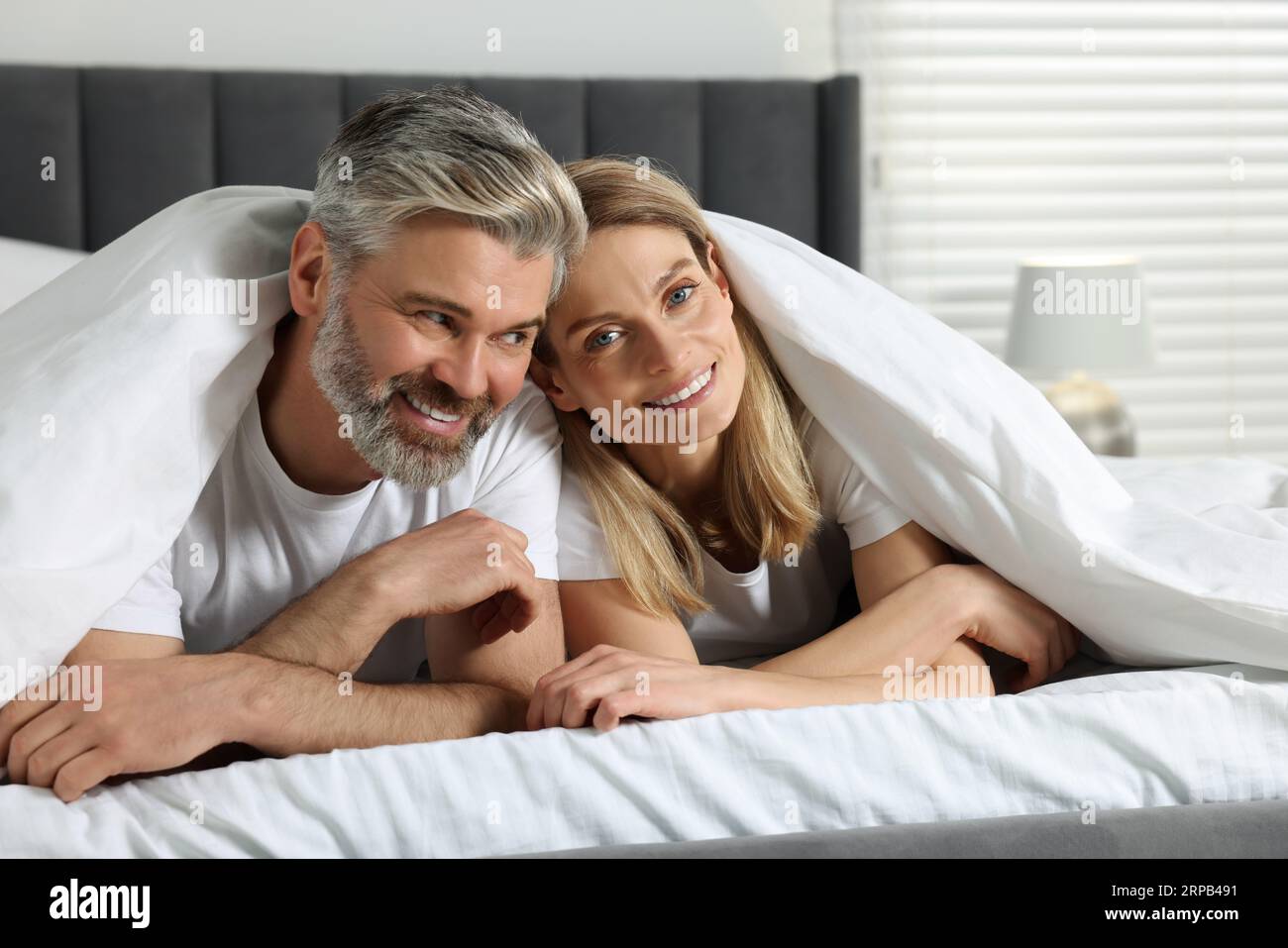 Lovely mature couple in bed at home Stock Photo - Alamy