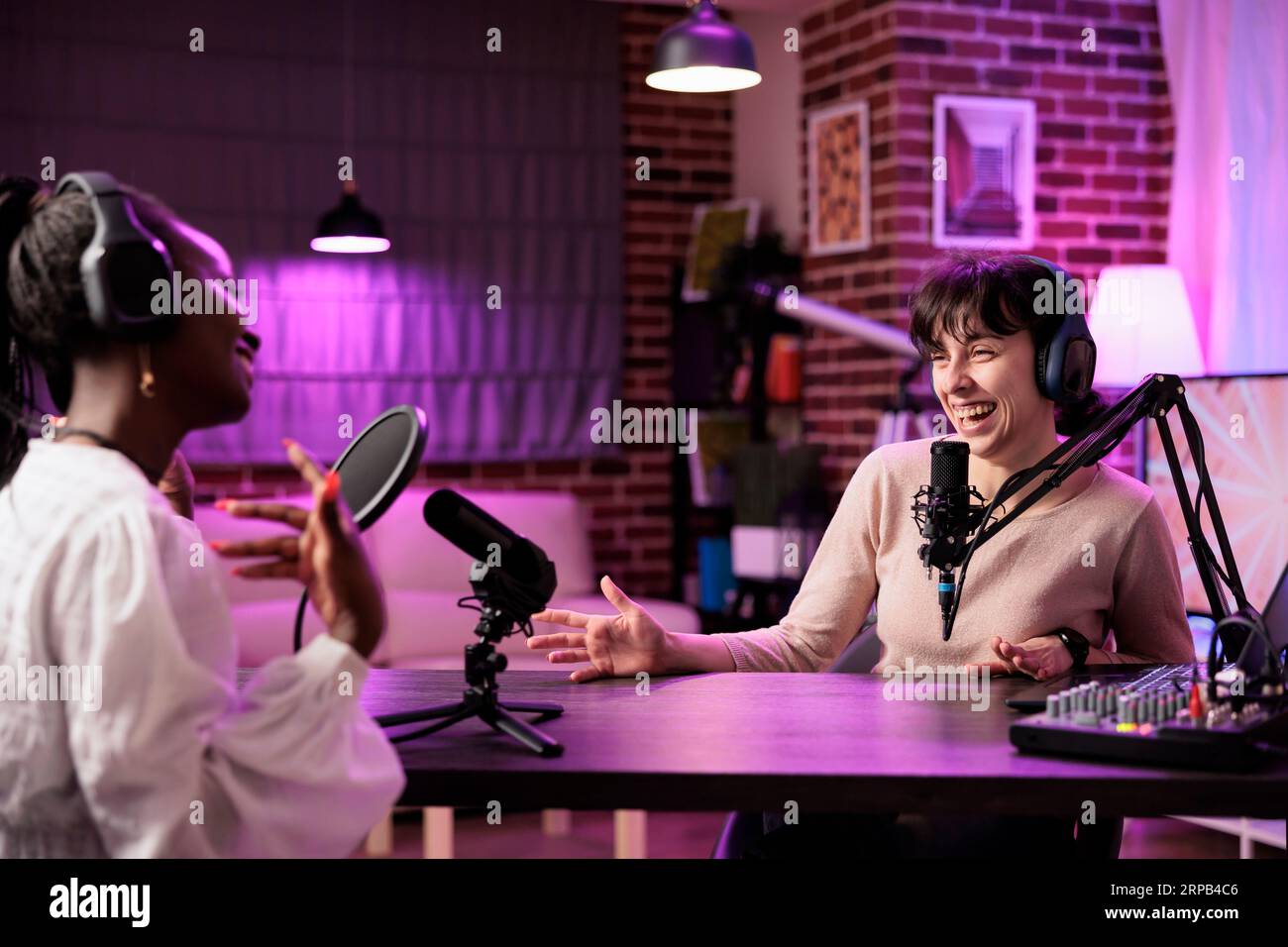 Online show host making guest laugh, cracking jokes during comedy ...