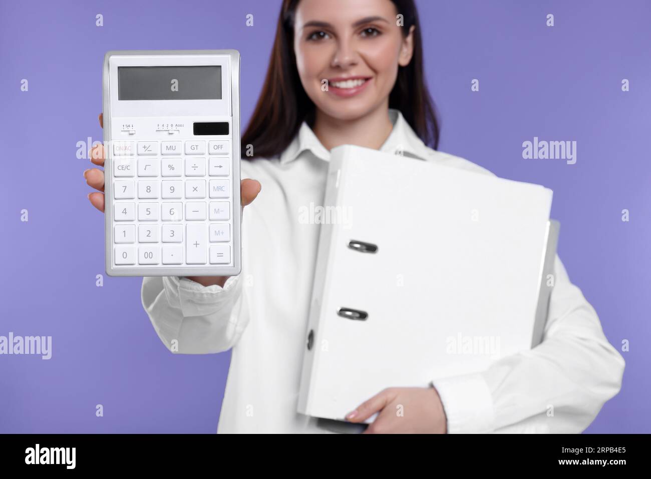 Smiling accountant with folders against purple background, focus on ...