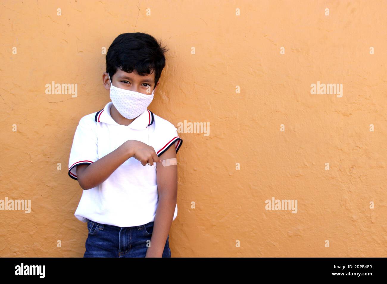 7-year-old Latino boy with black hair in a school uniform shirt and ...
