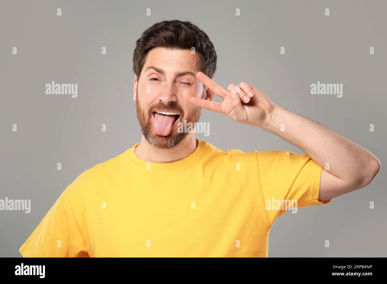V sign tongue hi-res stock photography and images - Alamy