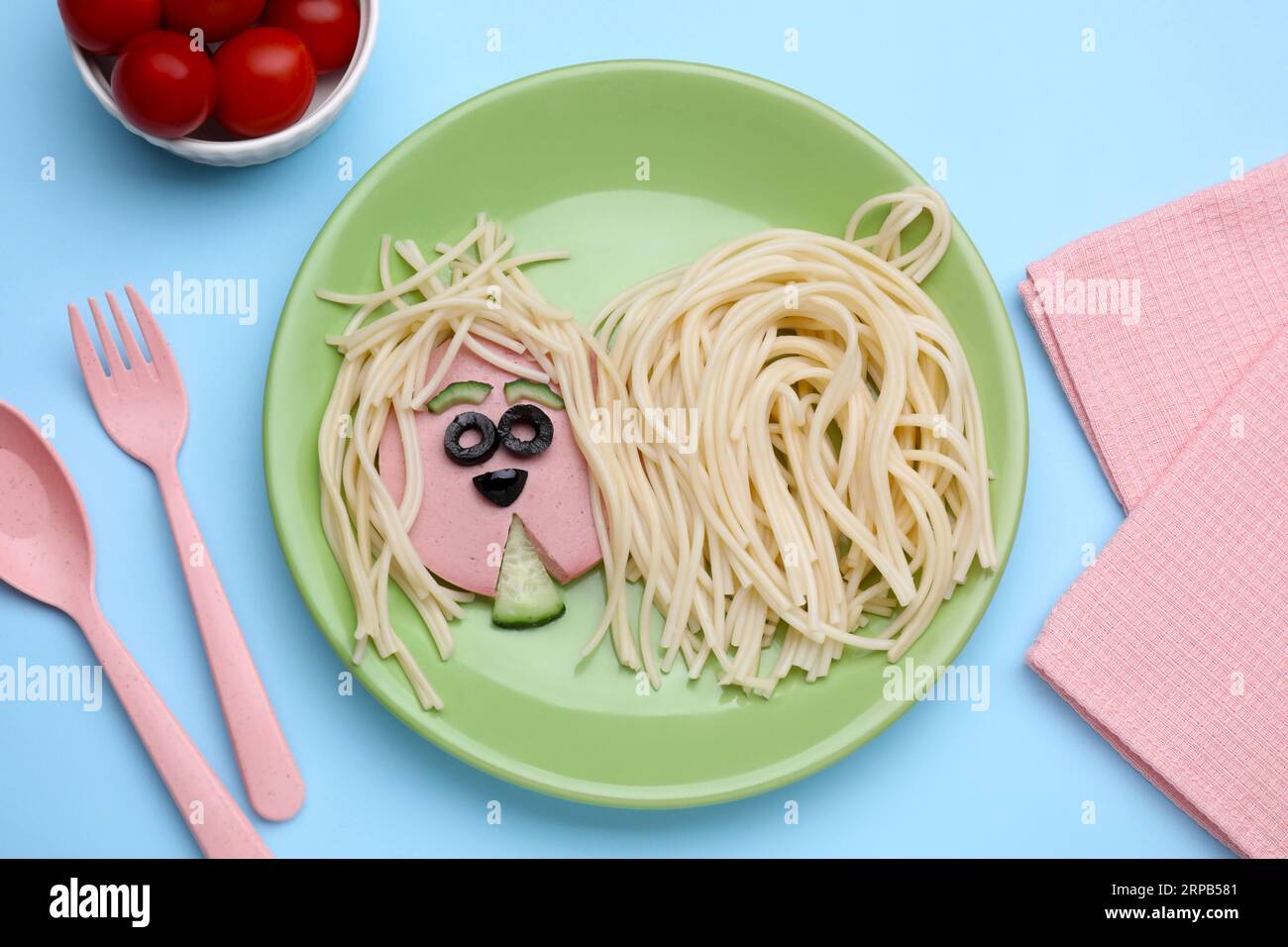Creative serving for kids. Plate with cute dog made of tasty pasta ...