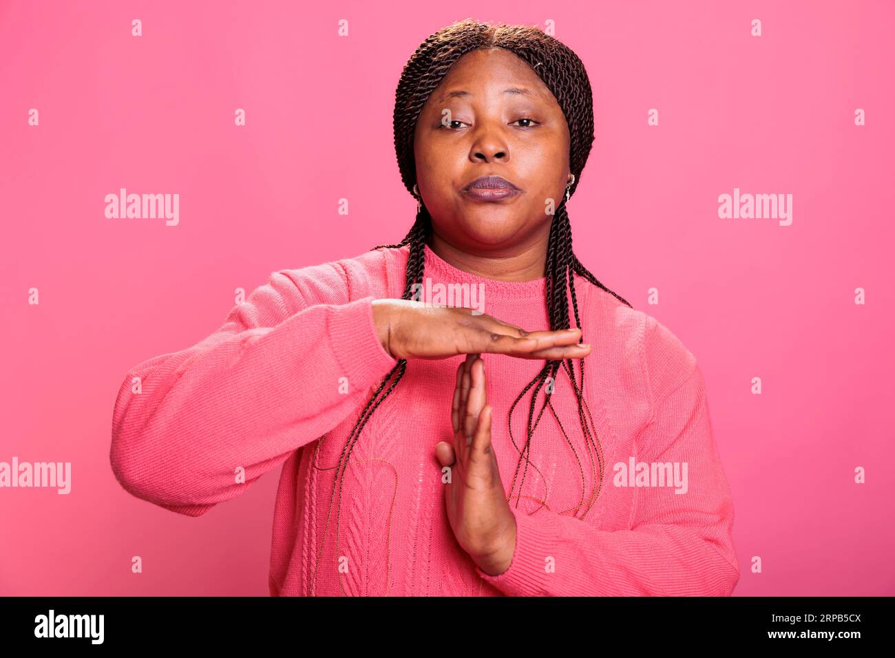 Angry woman doing timeout gesture with t shape hands making break time ...