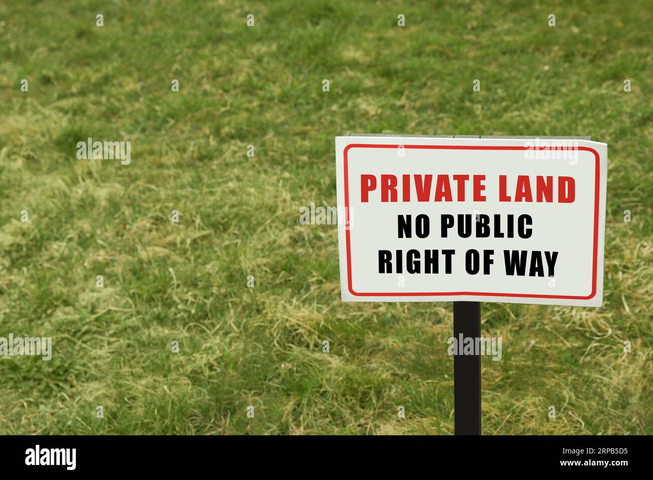 Sign with text Private Land No Public Right Of Way on green lawn Stock ...