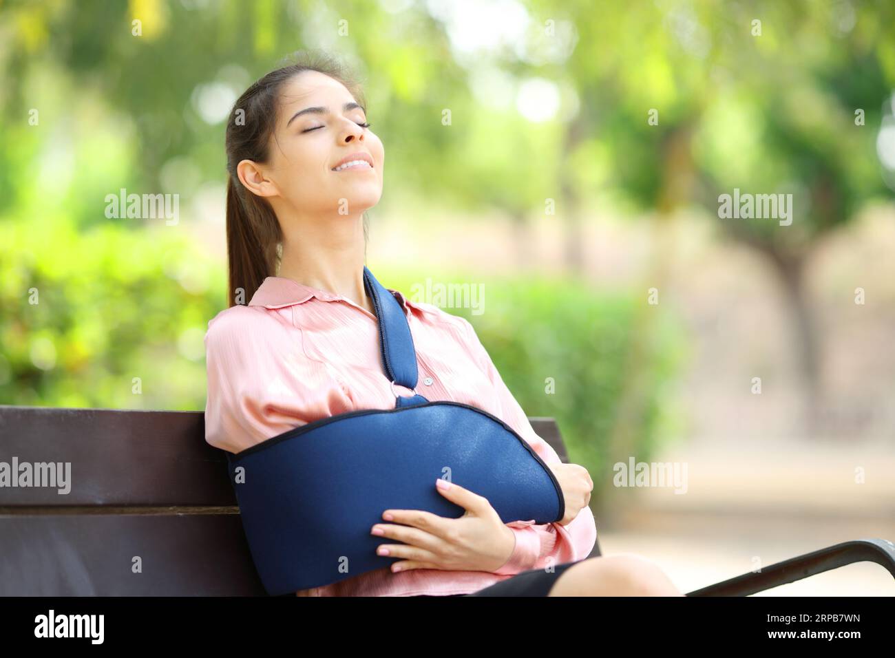 Happy disabled woman breathing sitting on a bench in a park Stock Photo ...