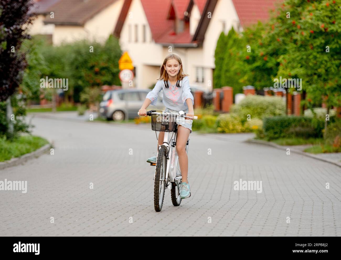 Cute preteen girl riding bycicle outdoors and smiling in beautiful ...