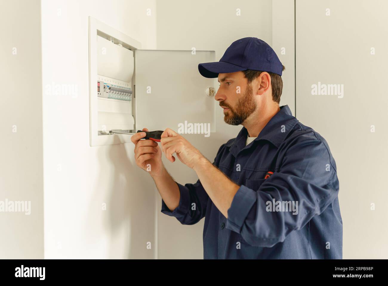 Professional male electrician inspect and repairing electrical systems ...