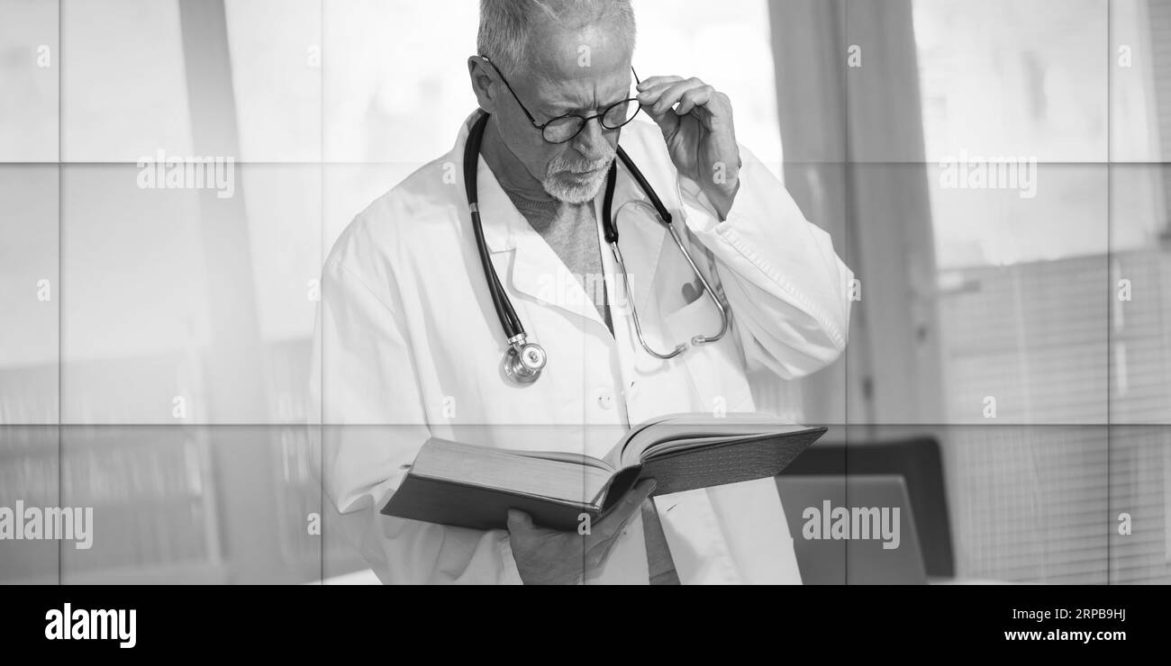 Doctor reading textbook in Black and White Stock Photos & Images - Alamy