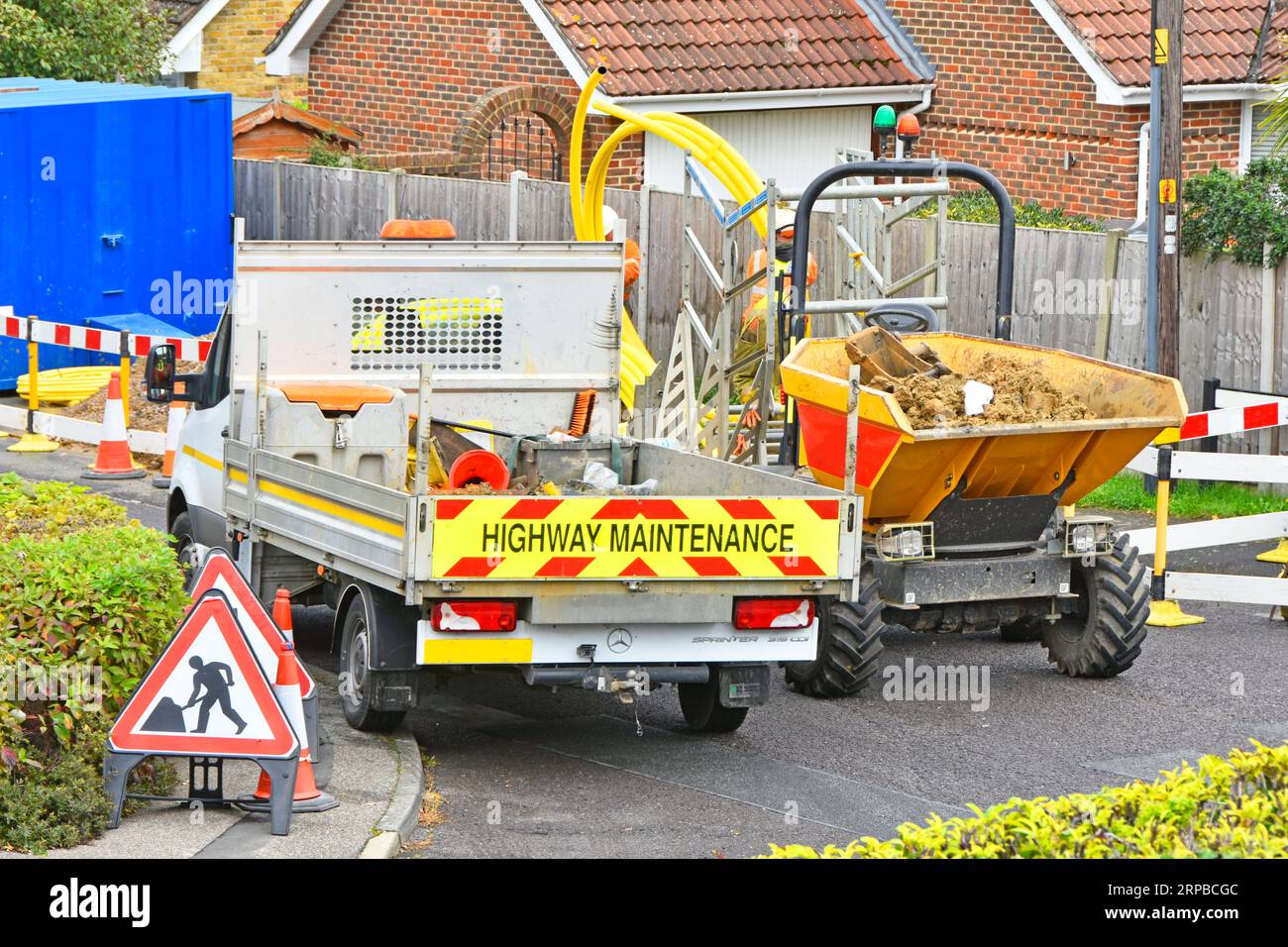 Highway maintenance tipper lorry & dumper truck block residential road ...