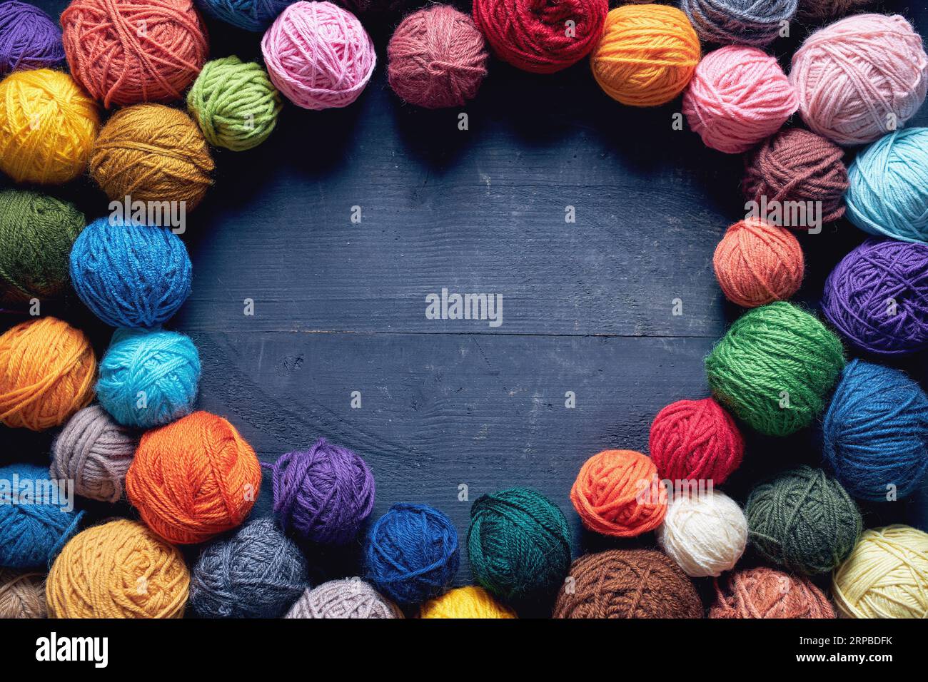 Colorful balls of wool on wooden table. Variety of yarn balls, view ...