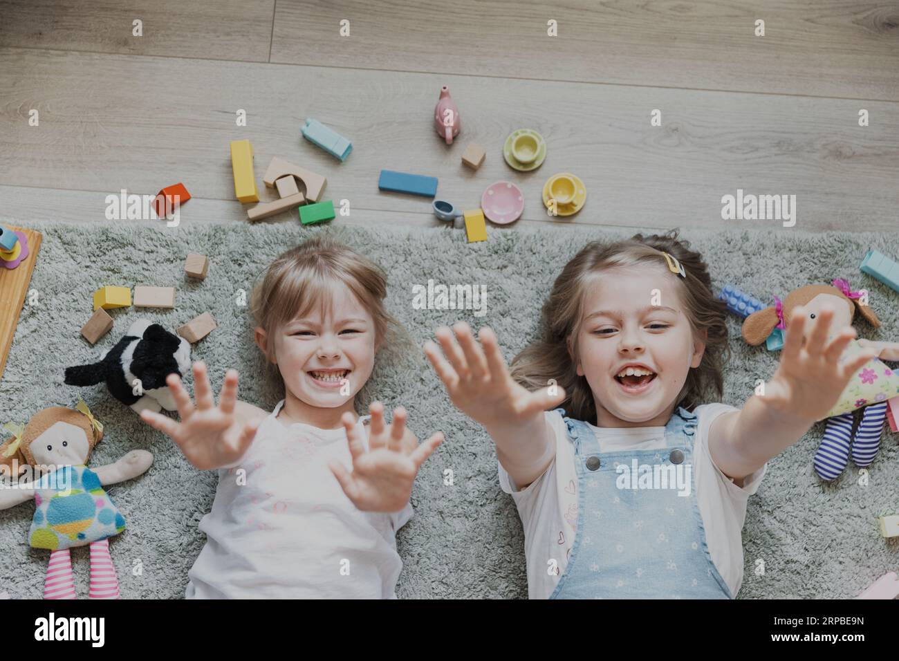 Top view from above on children playing with different toys. Portrait ...