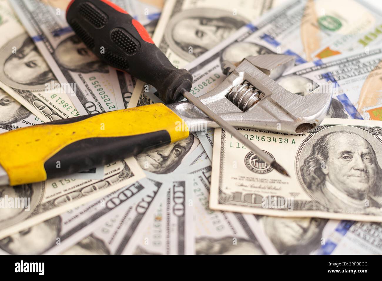 The dollar banknotes and tools Stock Photo - Alamy