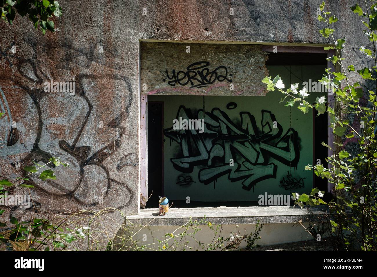 Facade of an abandoned building in the middle of nowhere with tags on ...