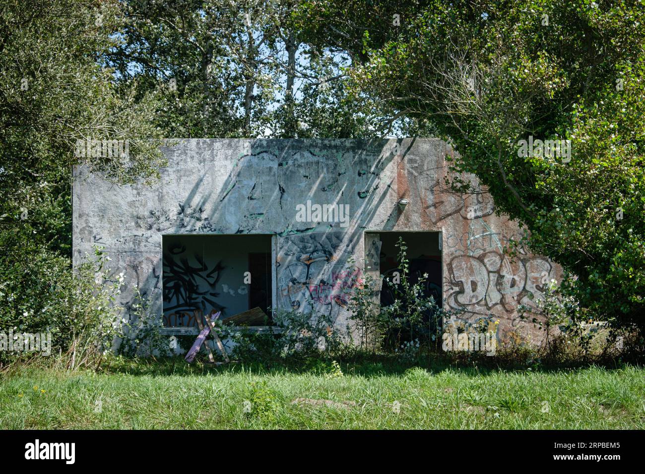 Facade of an abandoned building in the middle of nowhere with tags on ...