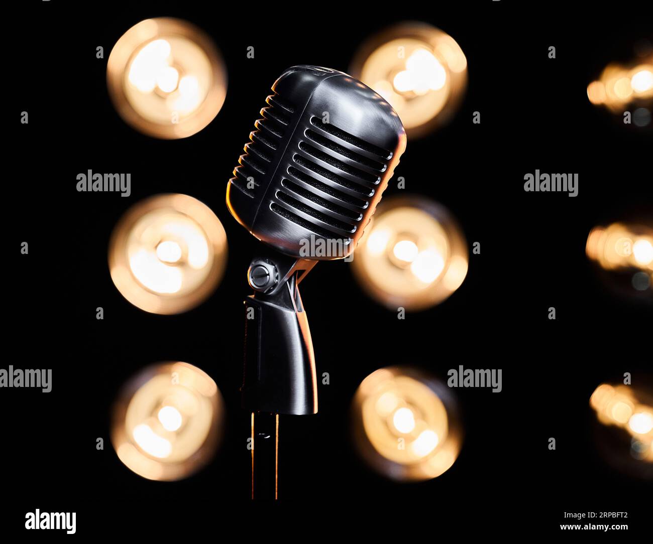 Close up of retro metal microphone, placed on dark stage during event ...