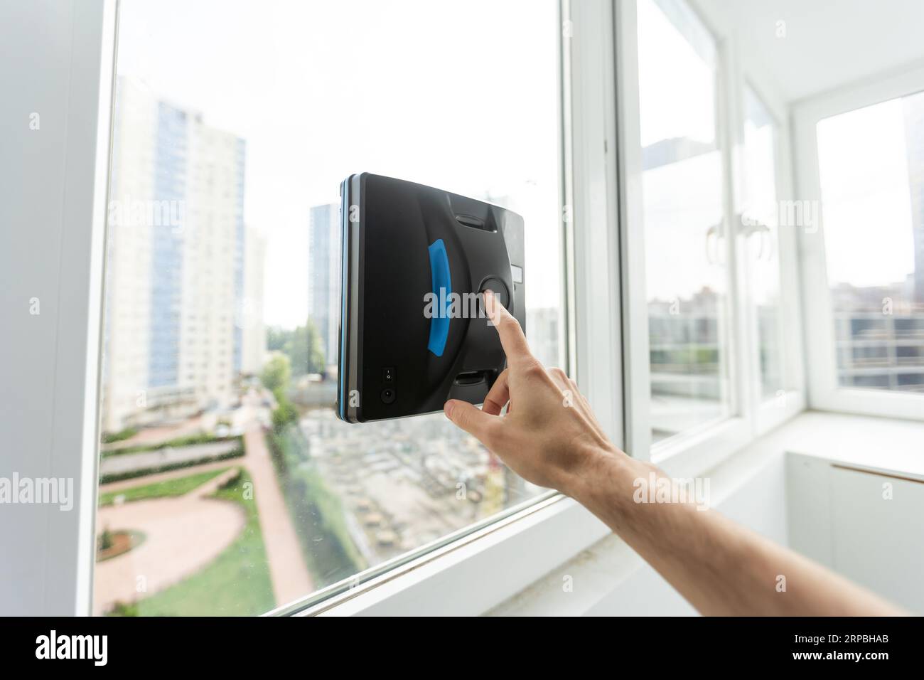 The white robotic window cleaner uses a brush and vacuum for a thorough ...