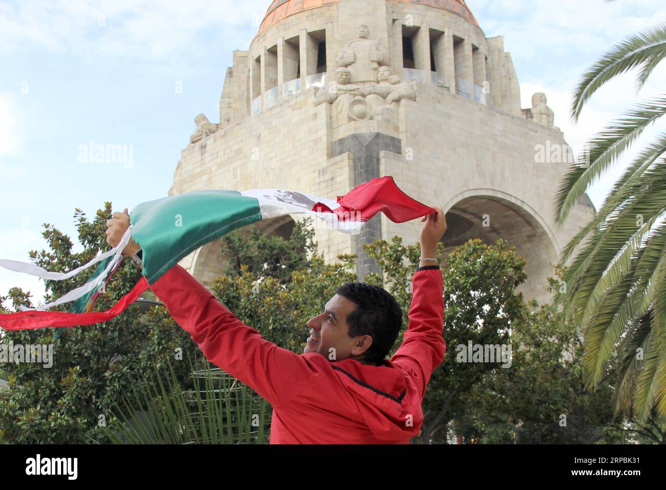Dark-haired latino adult man shows the flag of mexico proud of his ...