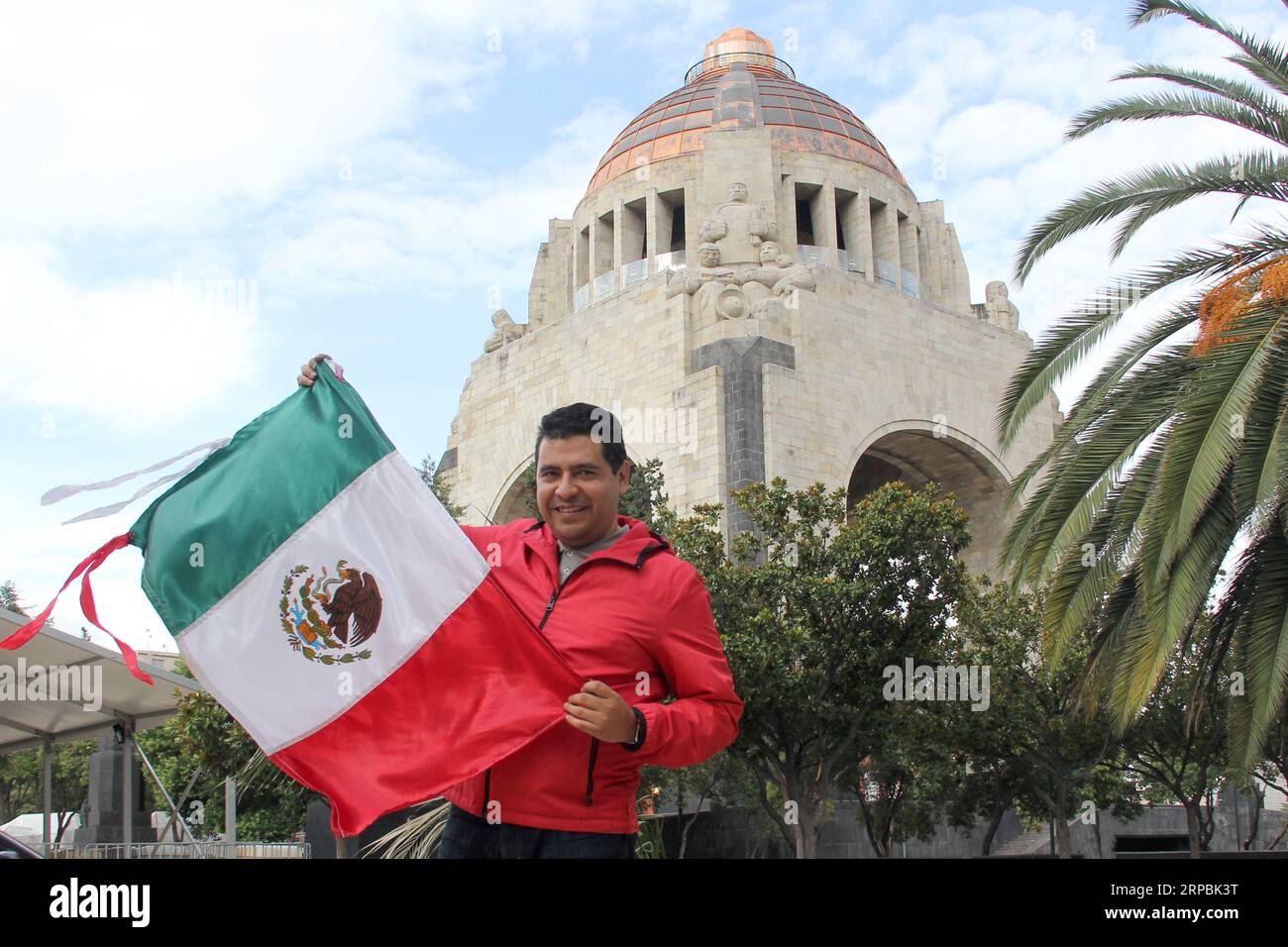 Dark-haired latino adult man shows the flag of mexico proud of his ...