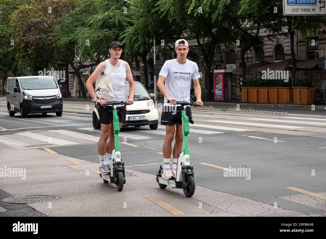 People on electric scooters through the streets Stock Photo - Alamy