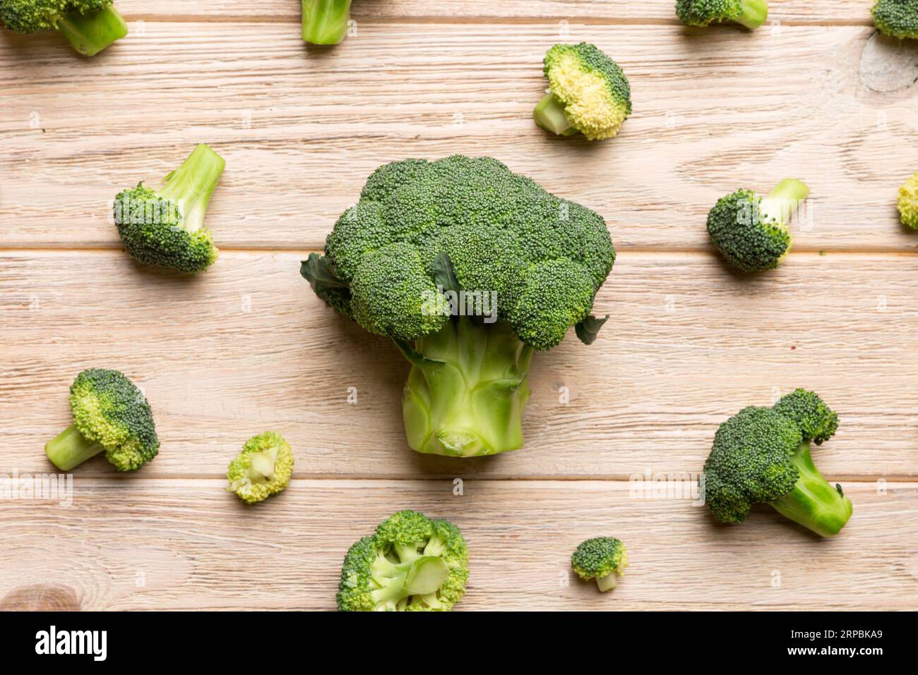 green fresh broccoli background close up on colored table. Vegetables ...