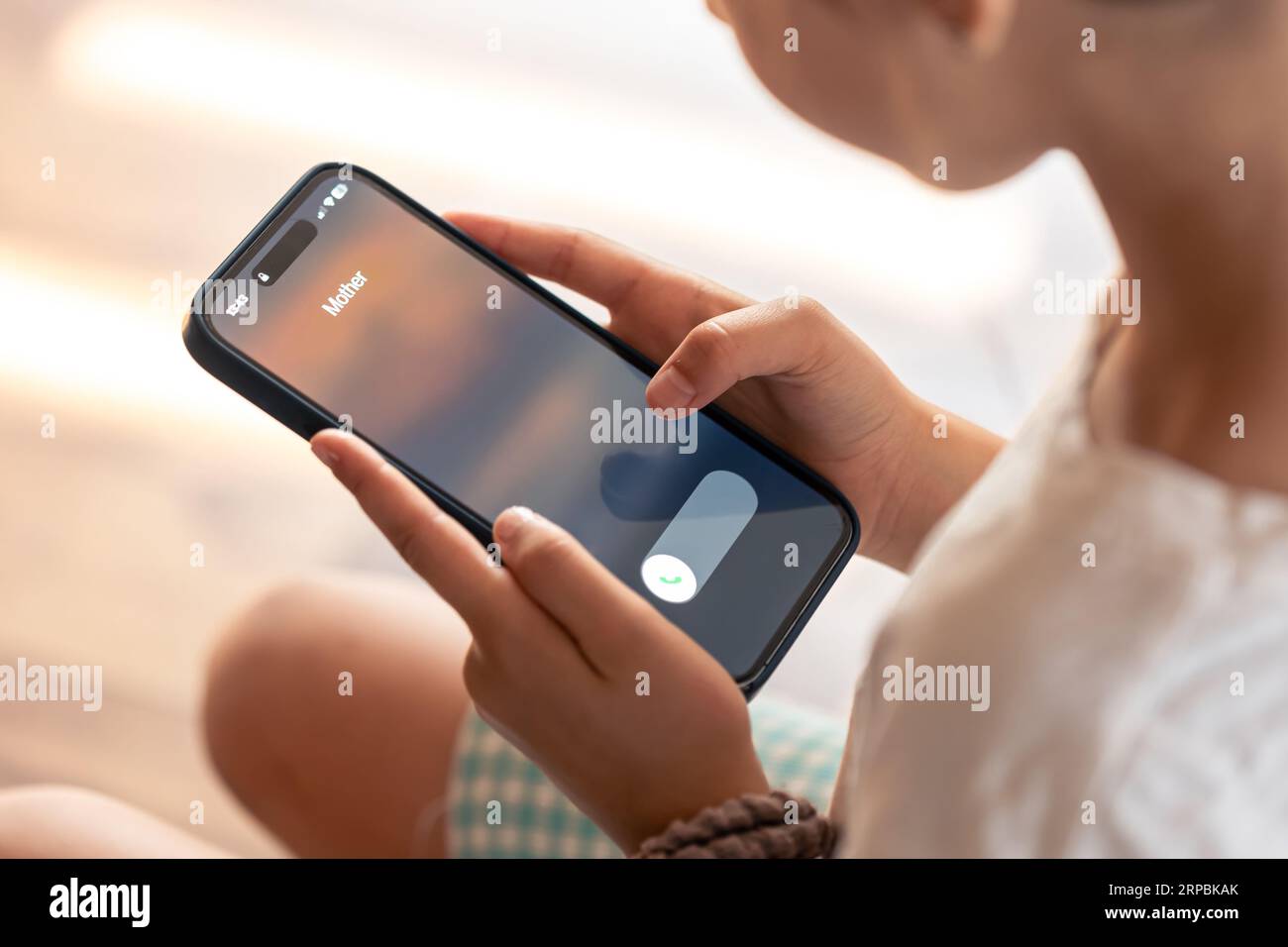 Smartphone in child hands with Incoming mother call on a screen Stock ...