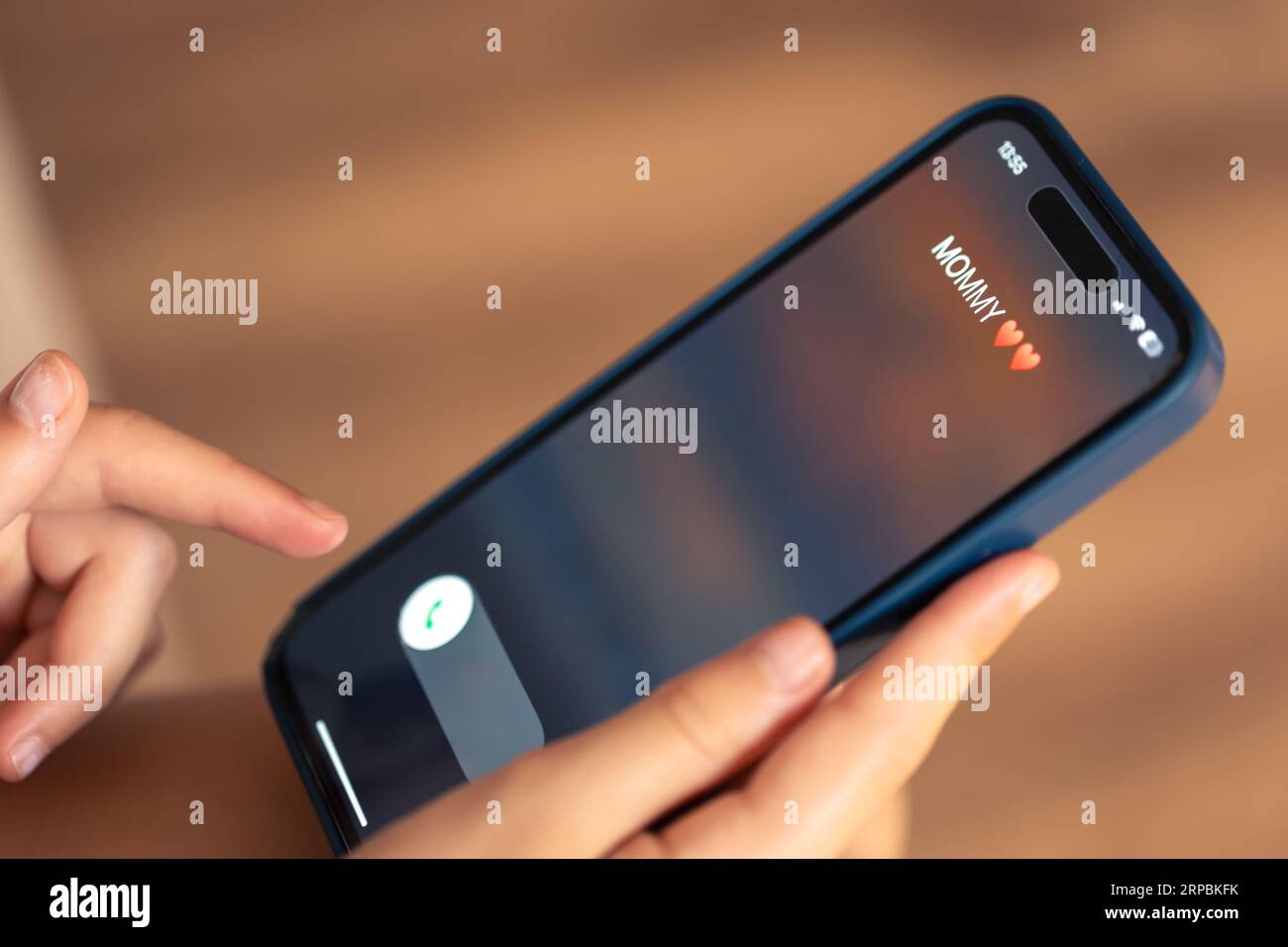 Smartphone in child hands with Incoming Mommy call on a screen Stock ...