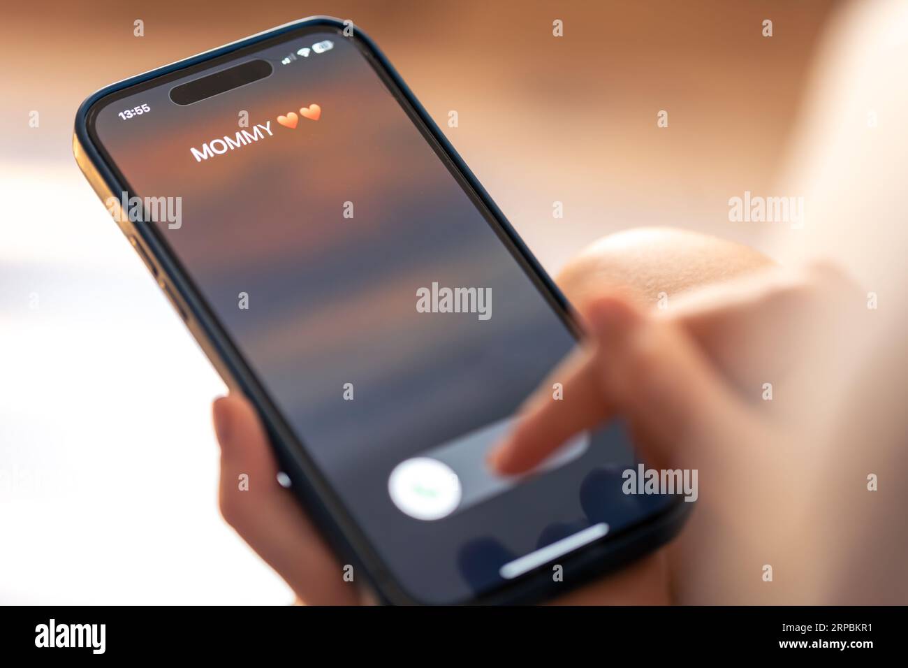 Smartphone in child hands with Incoming Mommy call on a screen Stock ...
