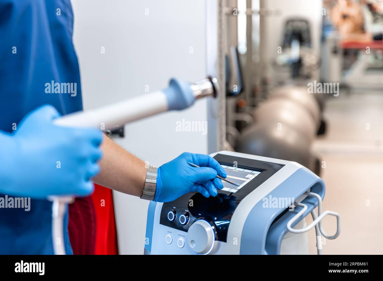 Shock wave therapy device with male doctor hands in rubber gloves Stock ...