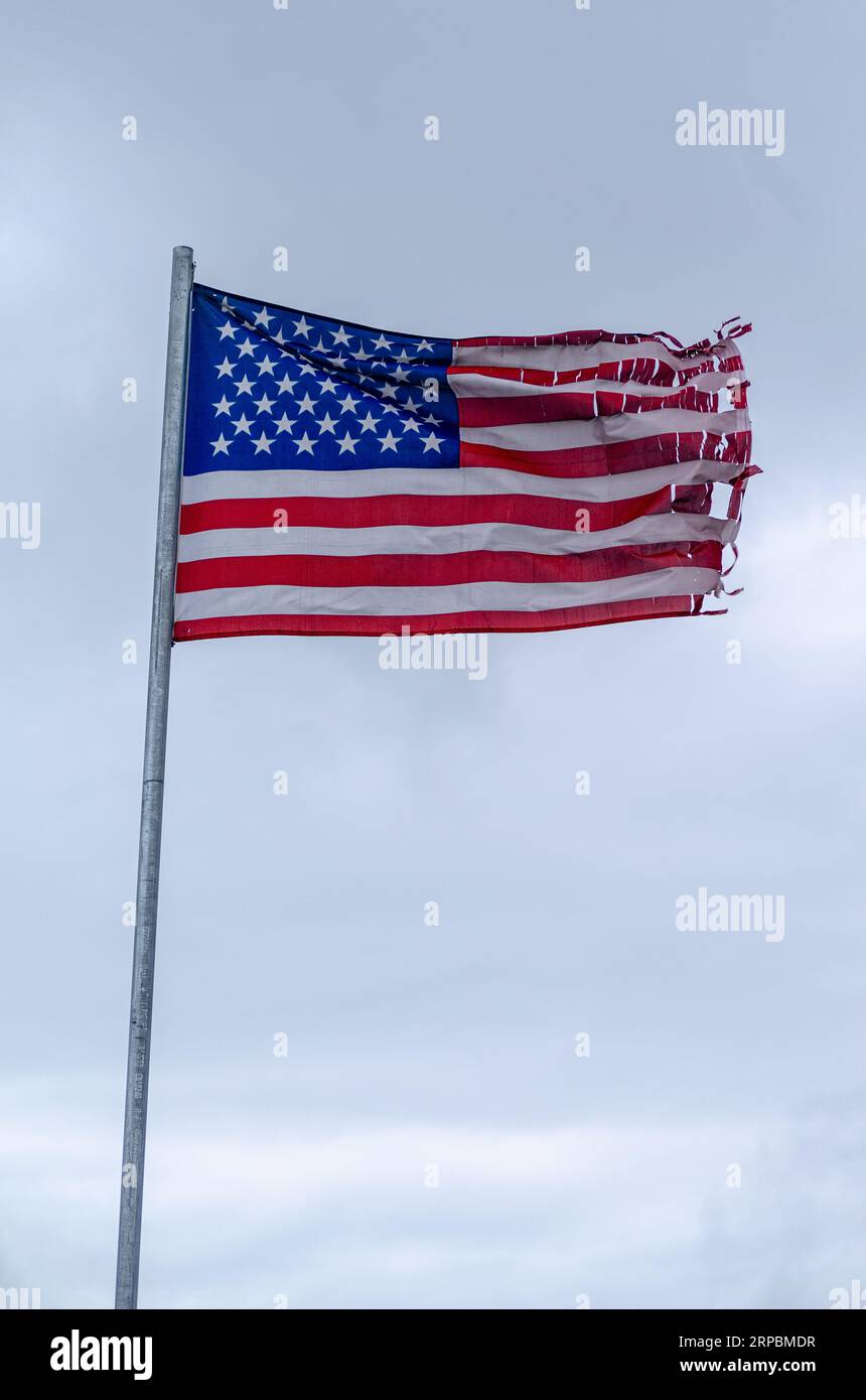 U.S. flag damaged by the weather Stock Photo - Alamy