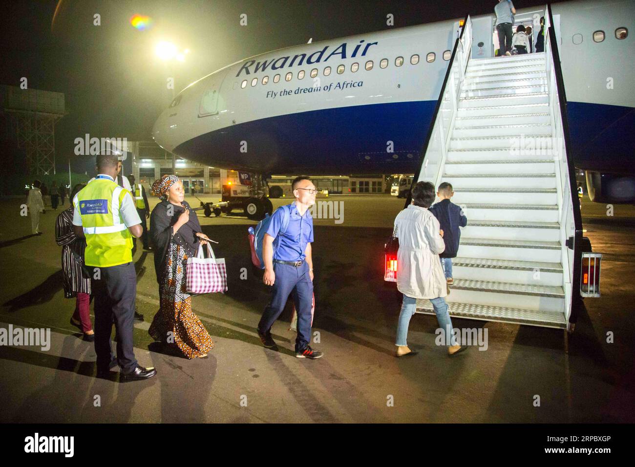 (190618) -- KIGALI, June 18, 2019 -- Passengers board RwandAir s flight ...