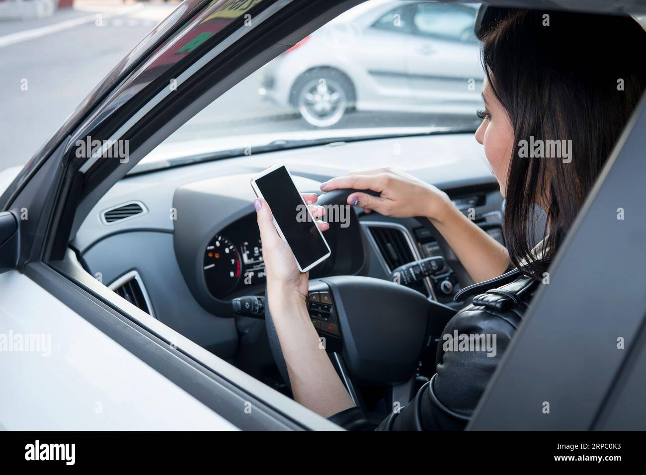 Dangerous driving smartphone driver checks hi-res stock photography and ...