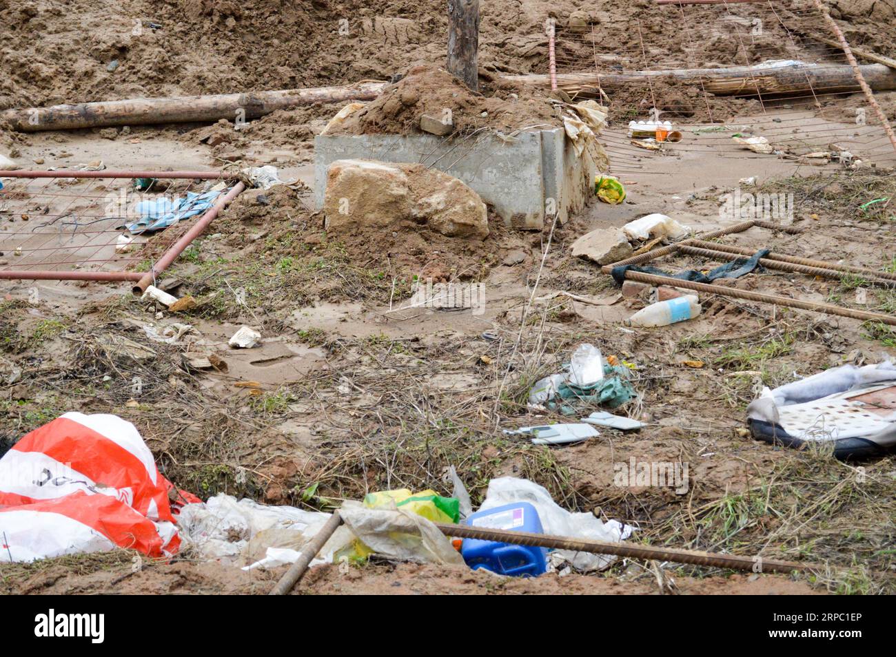 A mess at a construction site with scattered building materials and ...