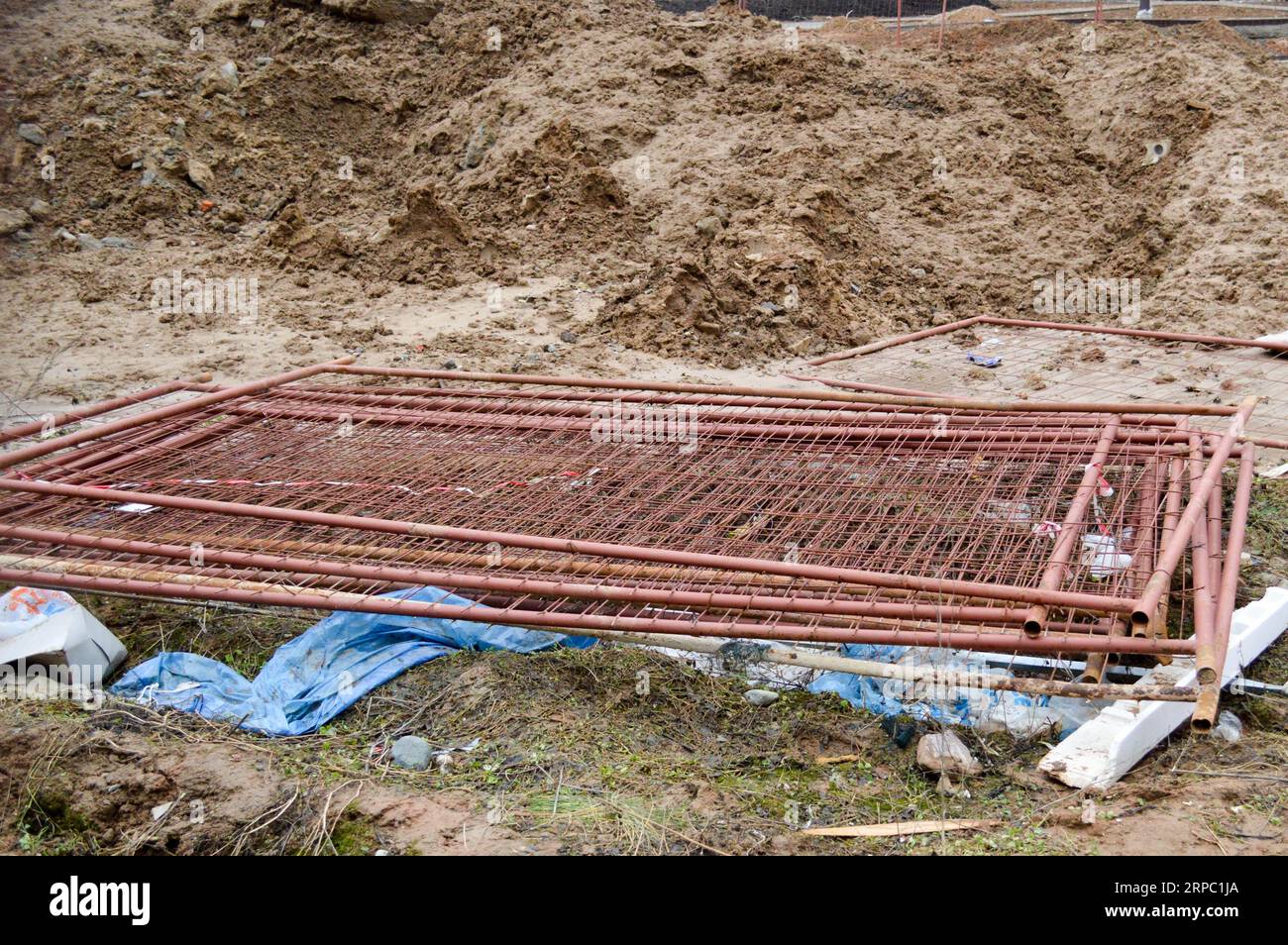A mess at a construction site with scattered building materials and ...