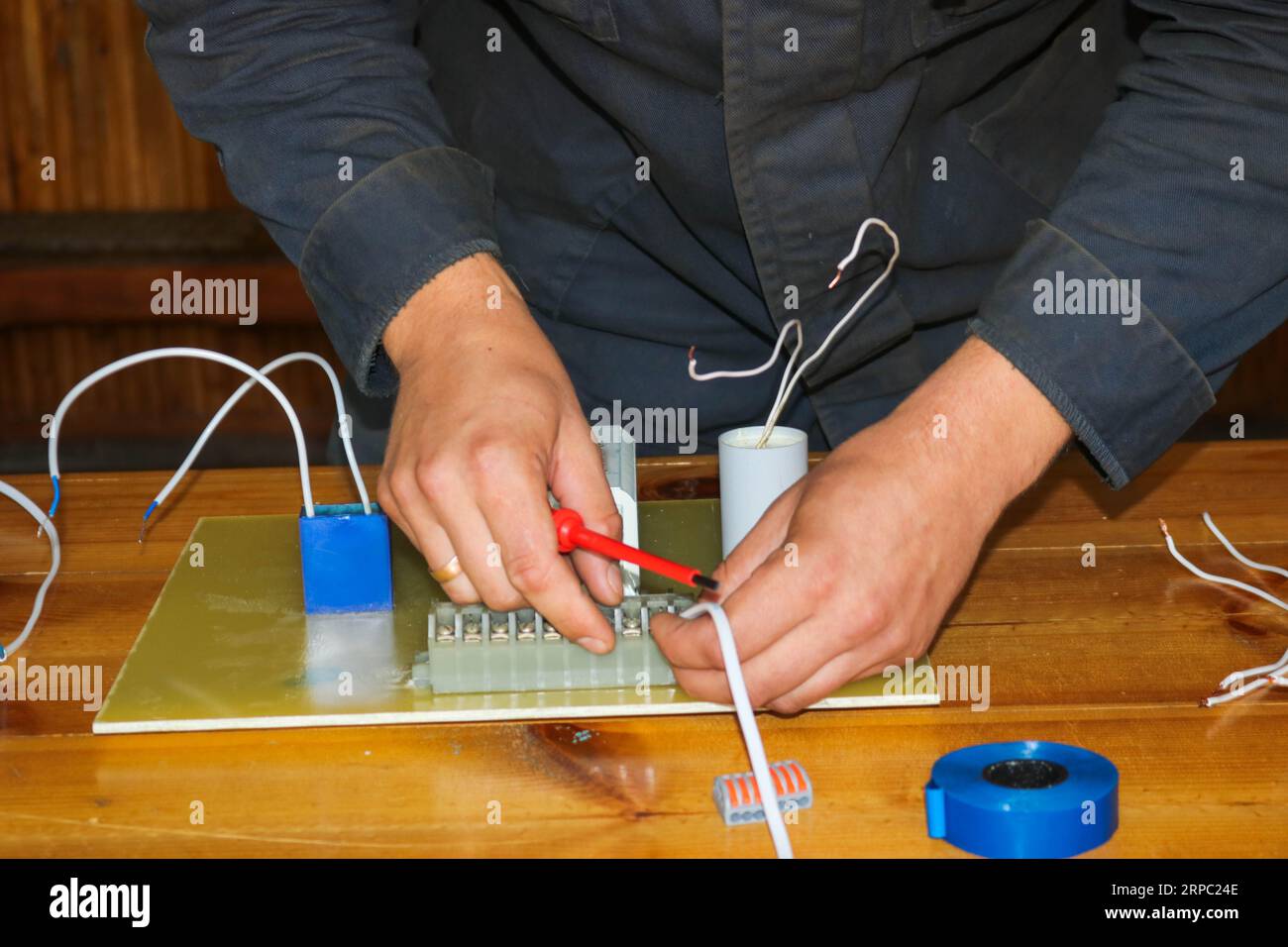 A man working electrician works, collects the electric circuit of a ...
