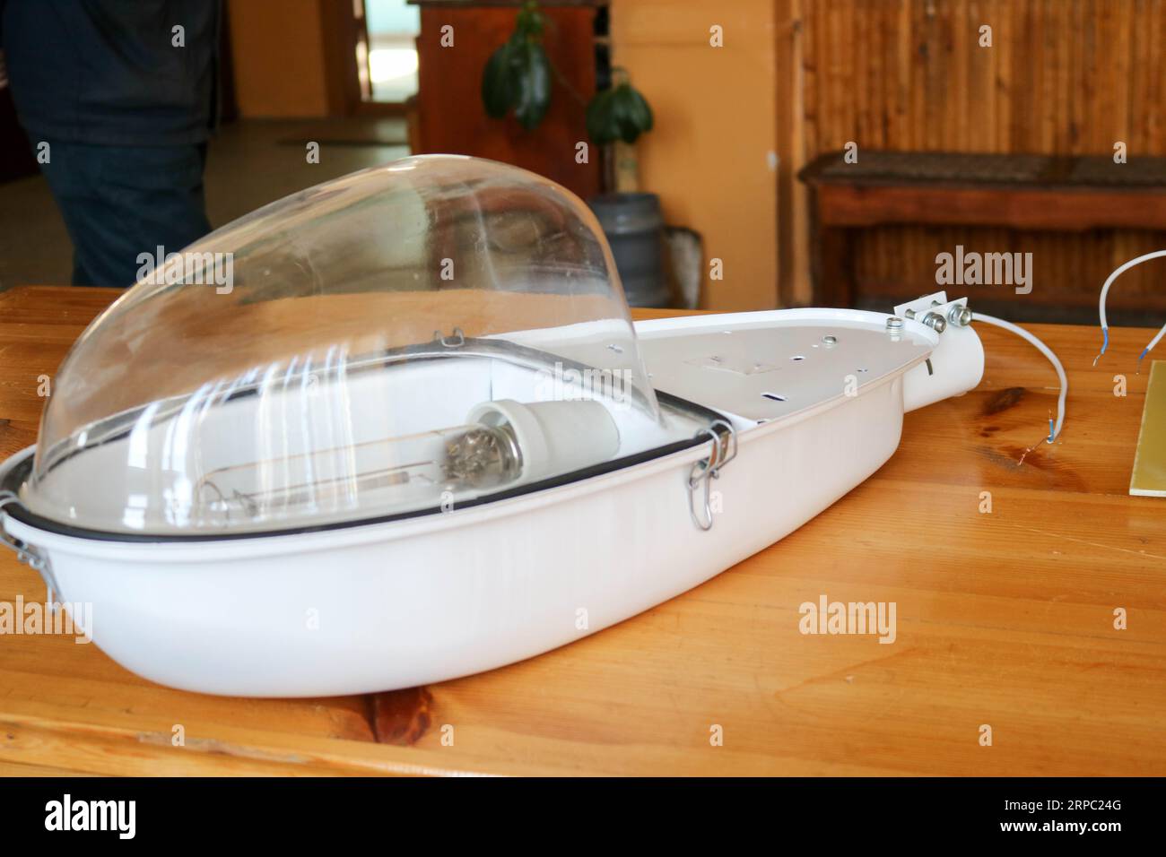 A large white disassembled street lamp with an electrical circuit with ...