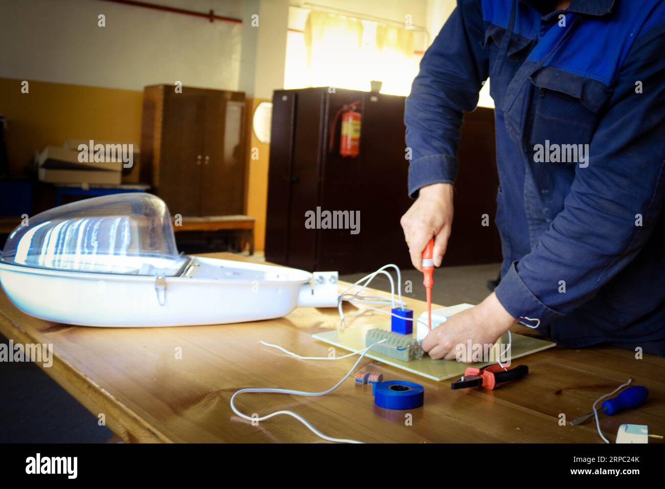 A man working electrician works, collects the electric circuit of a ...