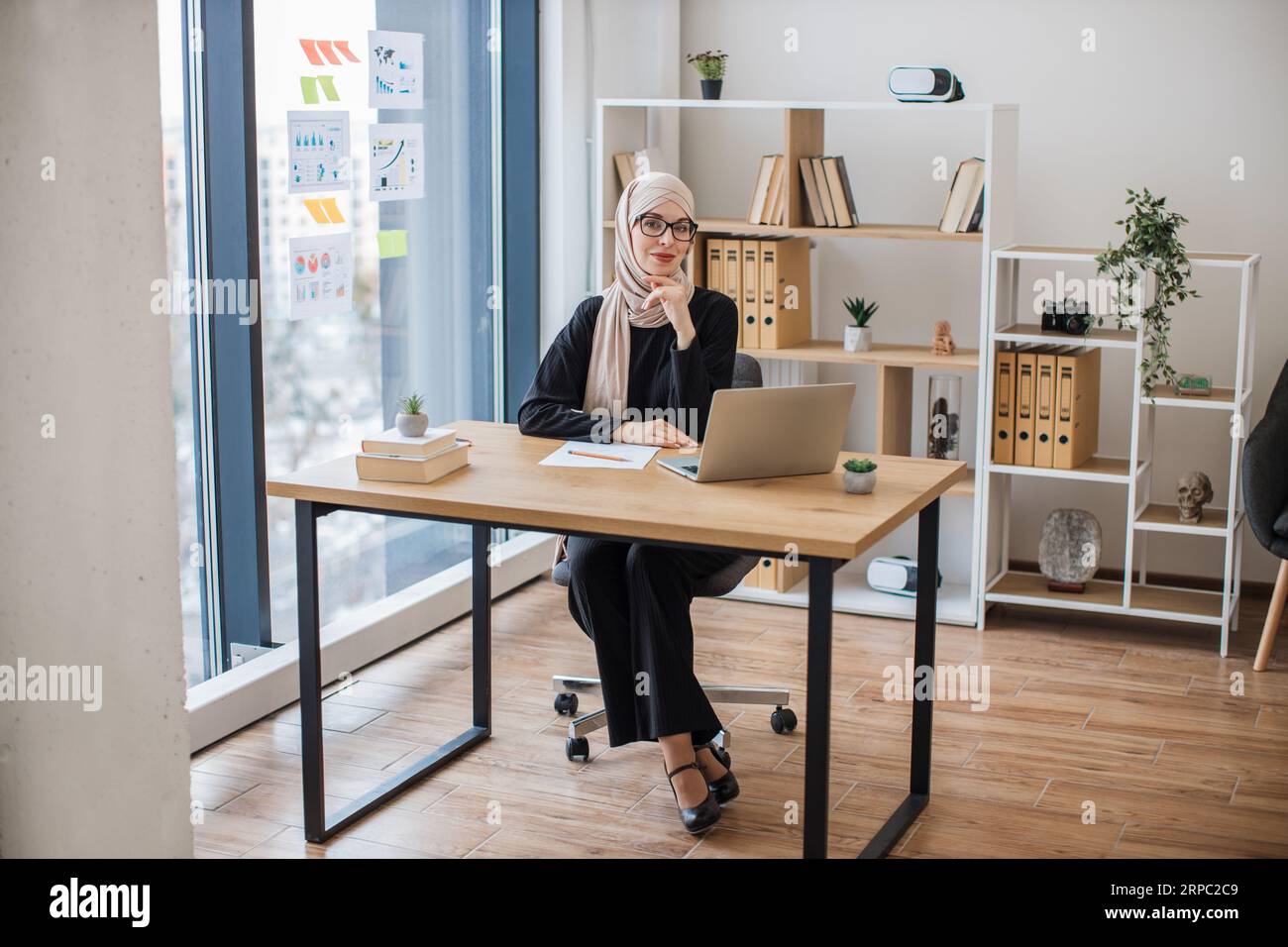 Woman posing behind computer on working day in office Stock Photo - Alamy
