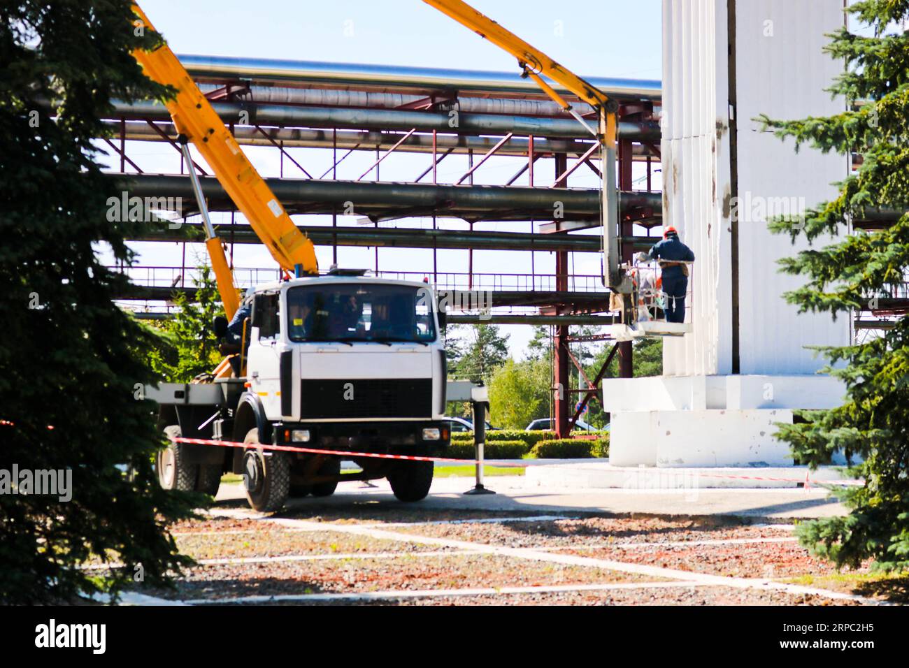 Repair columns on a special technique. Workers on the crane repair a ...