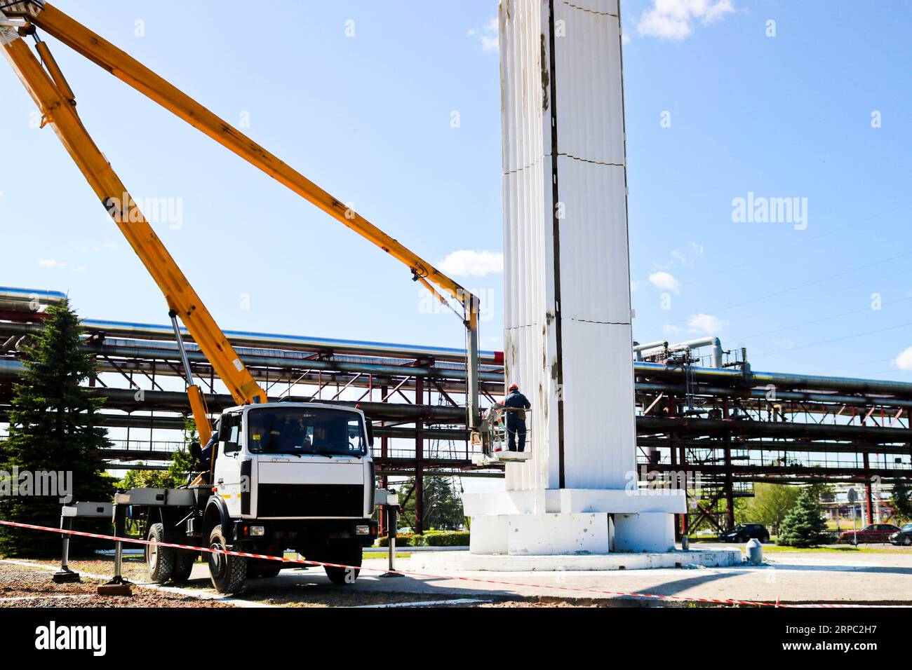 Repair columns on a special technique. Workers on the crane repair a ...