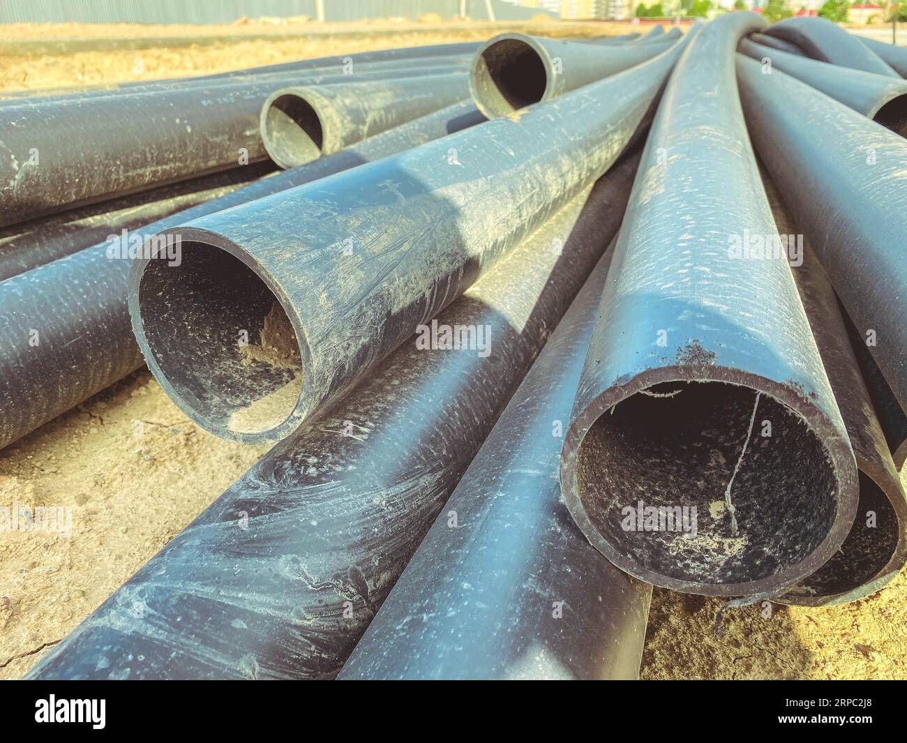 construction of a sewerage system in a new microdistrict. black rubber ...