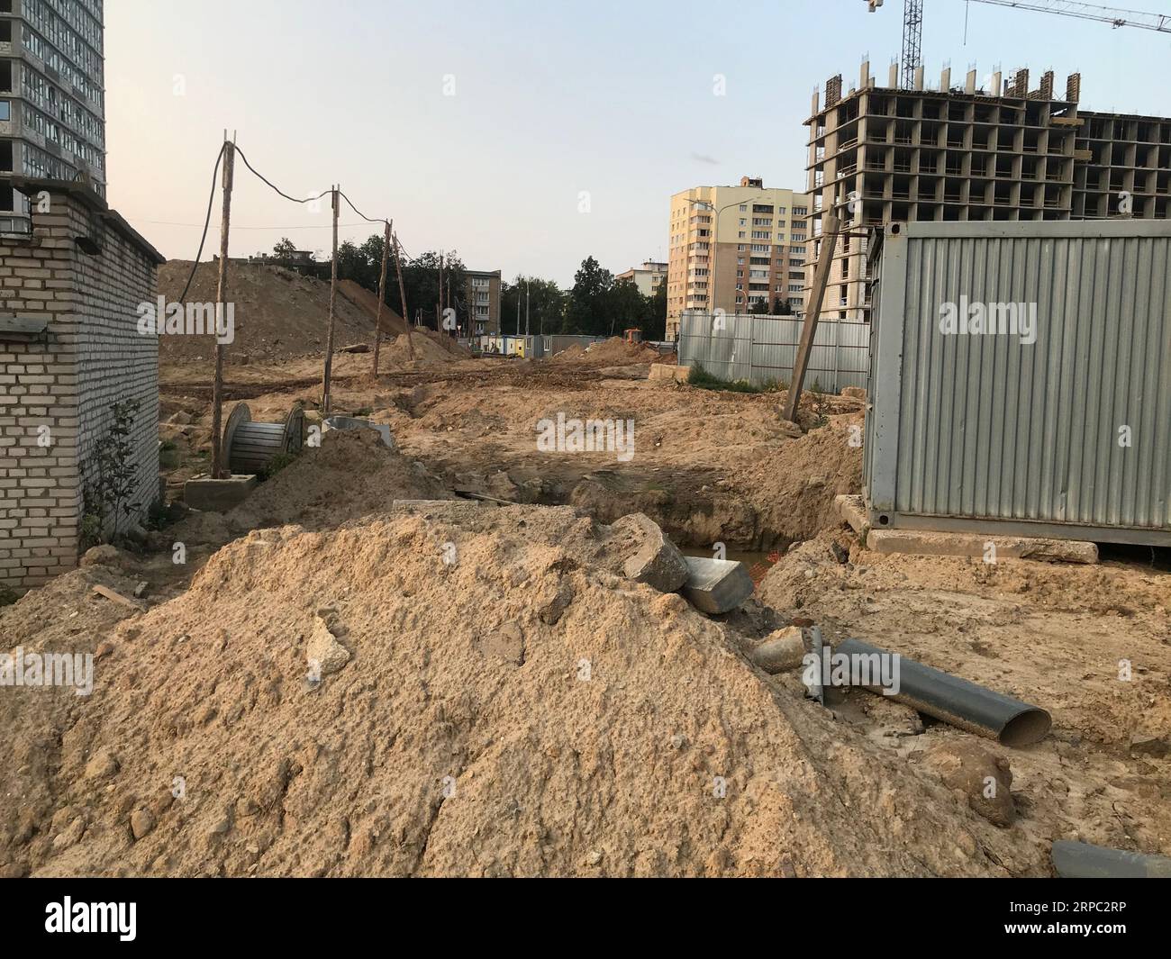 sand at a construction site. the builders dug a ditch for laying ...
