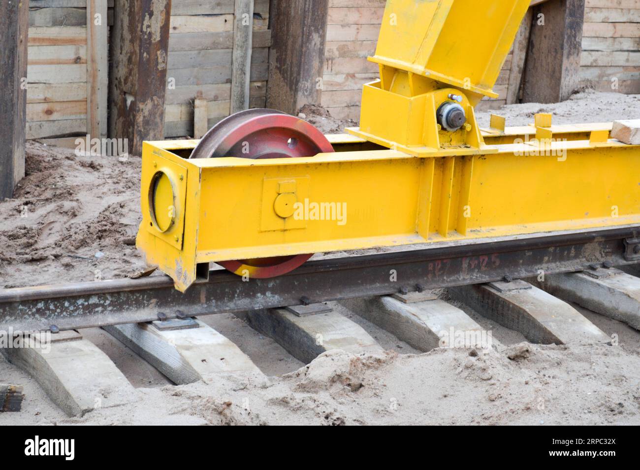 Large iron metal yellow supports on rails with wheels with an induction ...