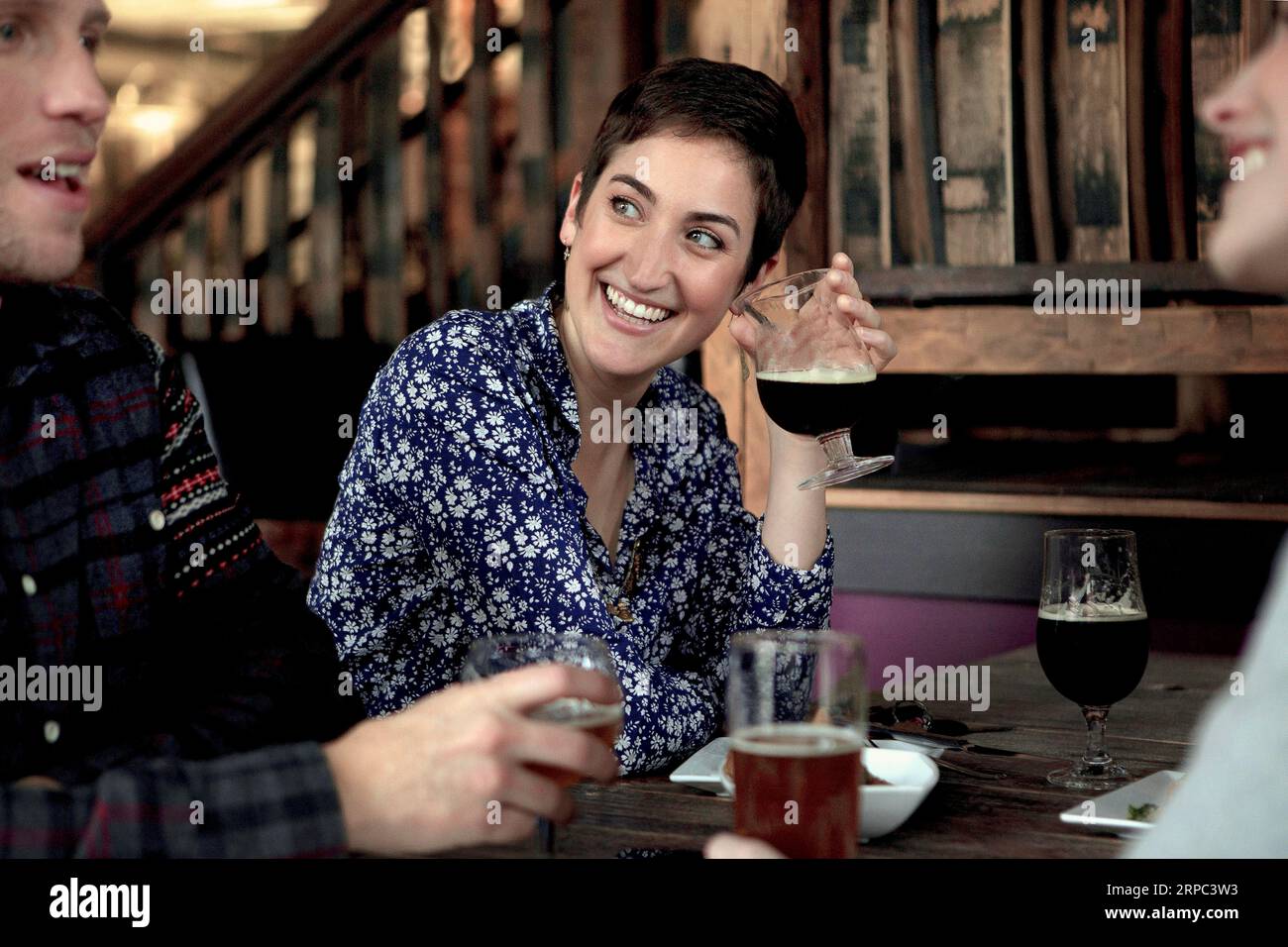 Friends relaxing in pub Stock Photo - Alamy