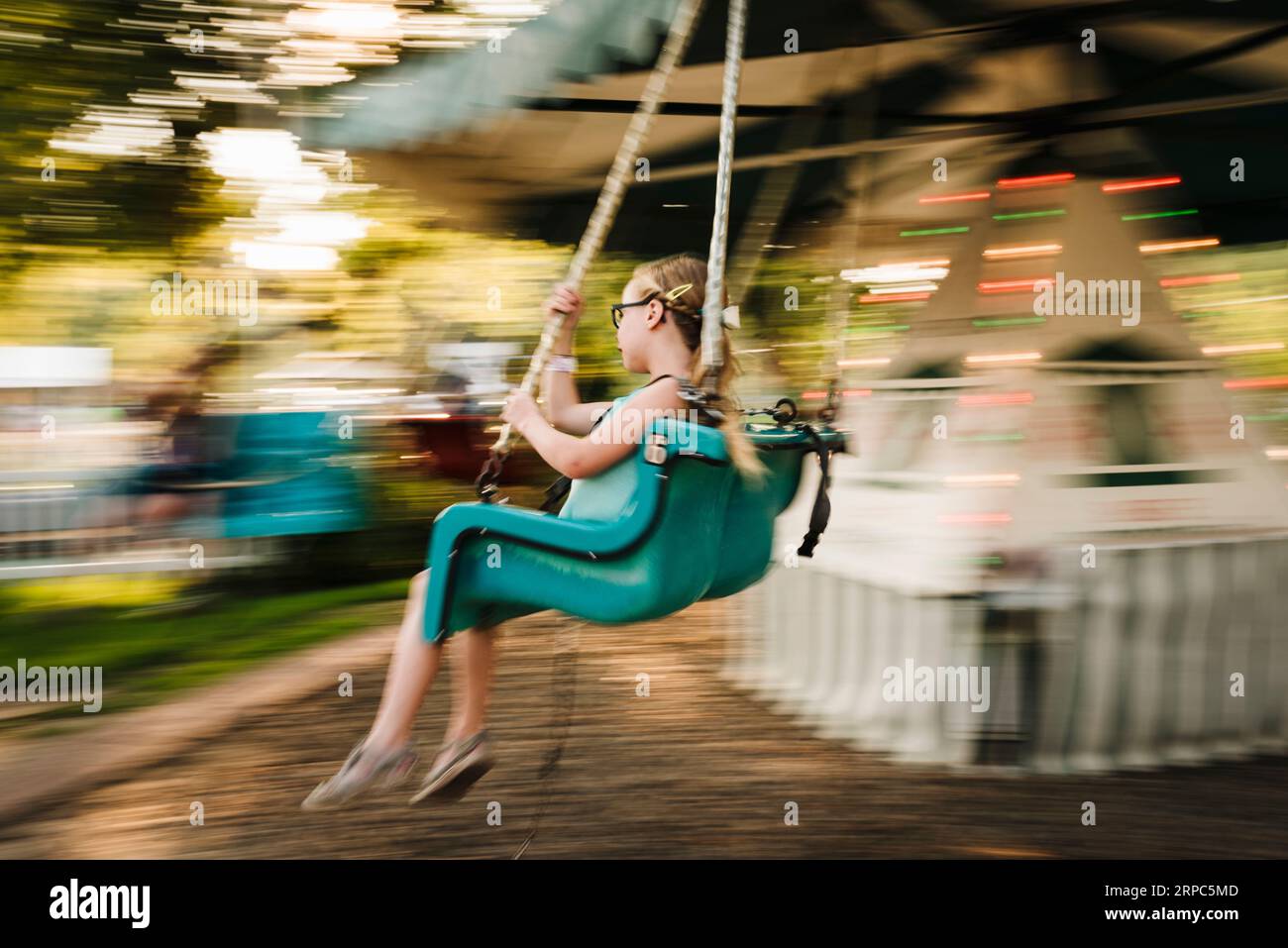 Child swinging on chair hi-res stock photography and images - Alamy
